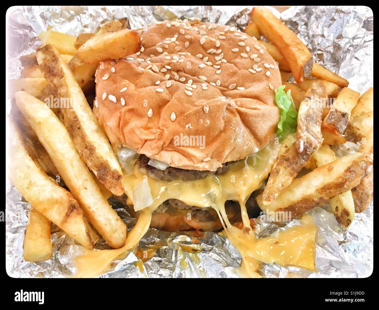 Cheeseburger and fries Stock Photo - Alamy