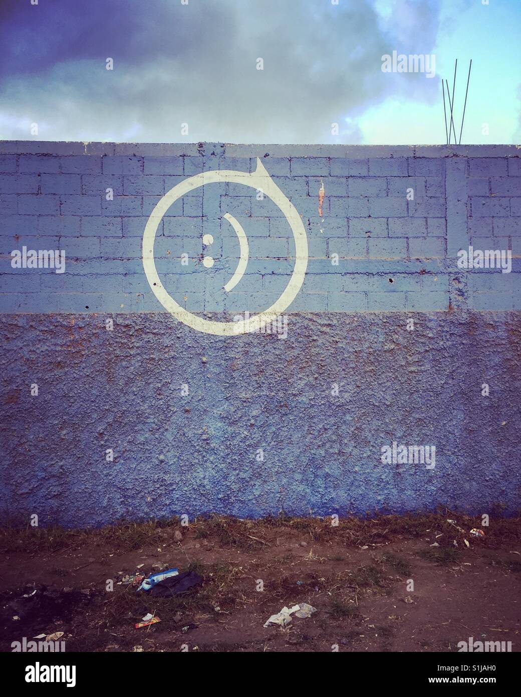 Sideways smiley face on blue wall in Guatemala Stock Photo - Alamy