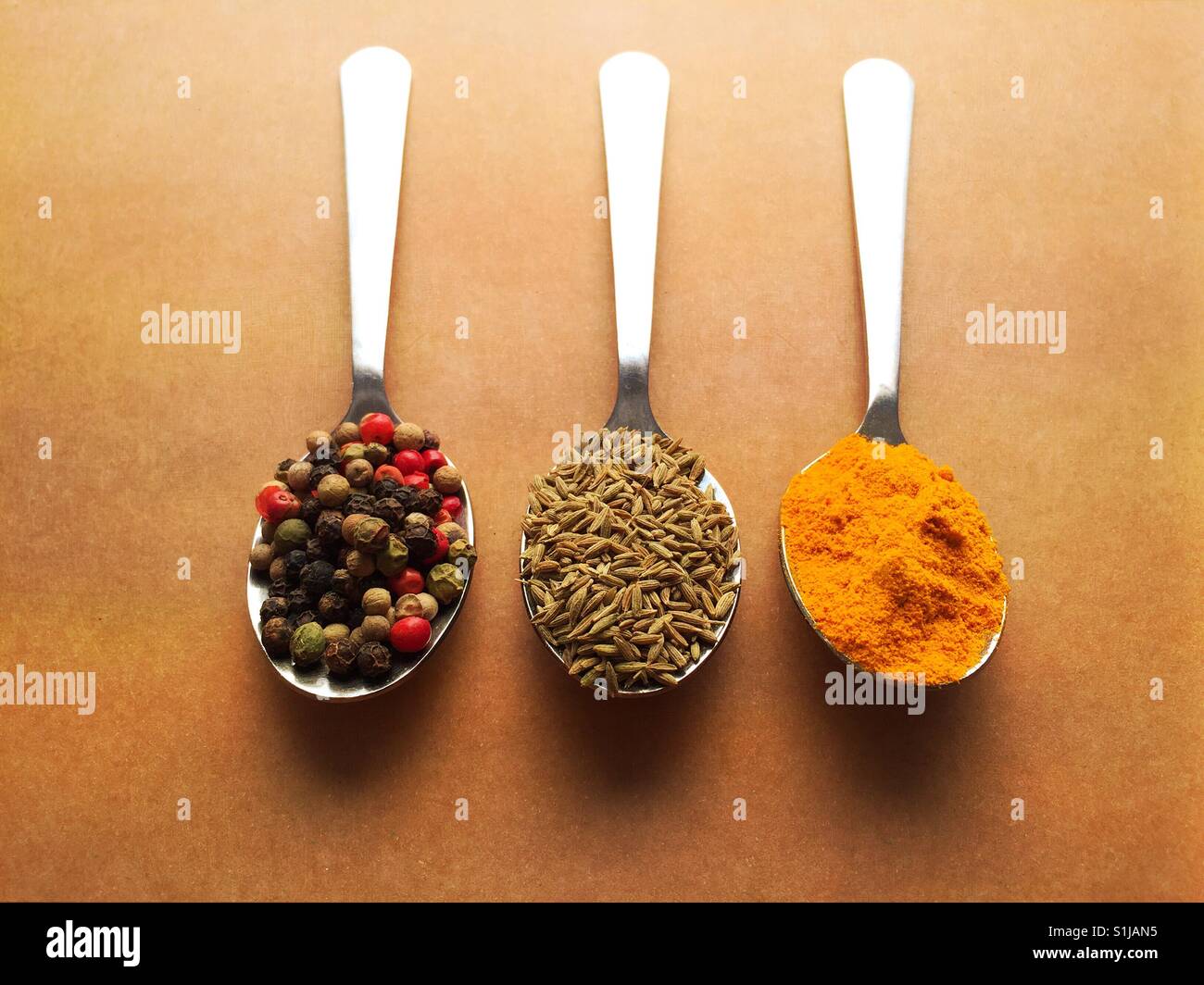 A close-up shot of three spoons containing three different spices Stock ...