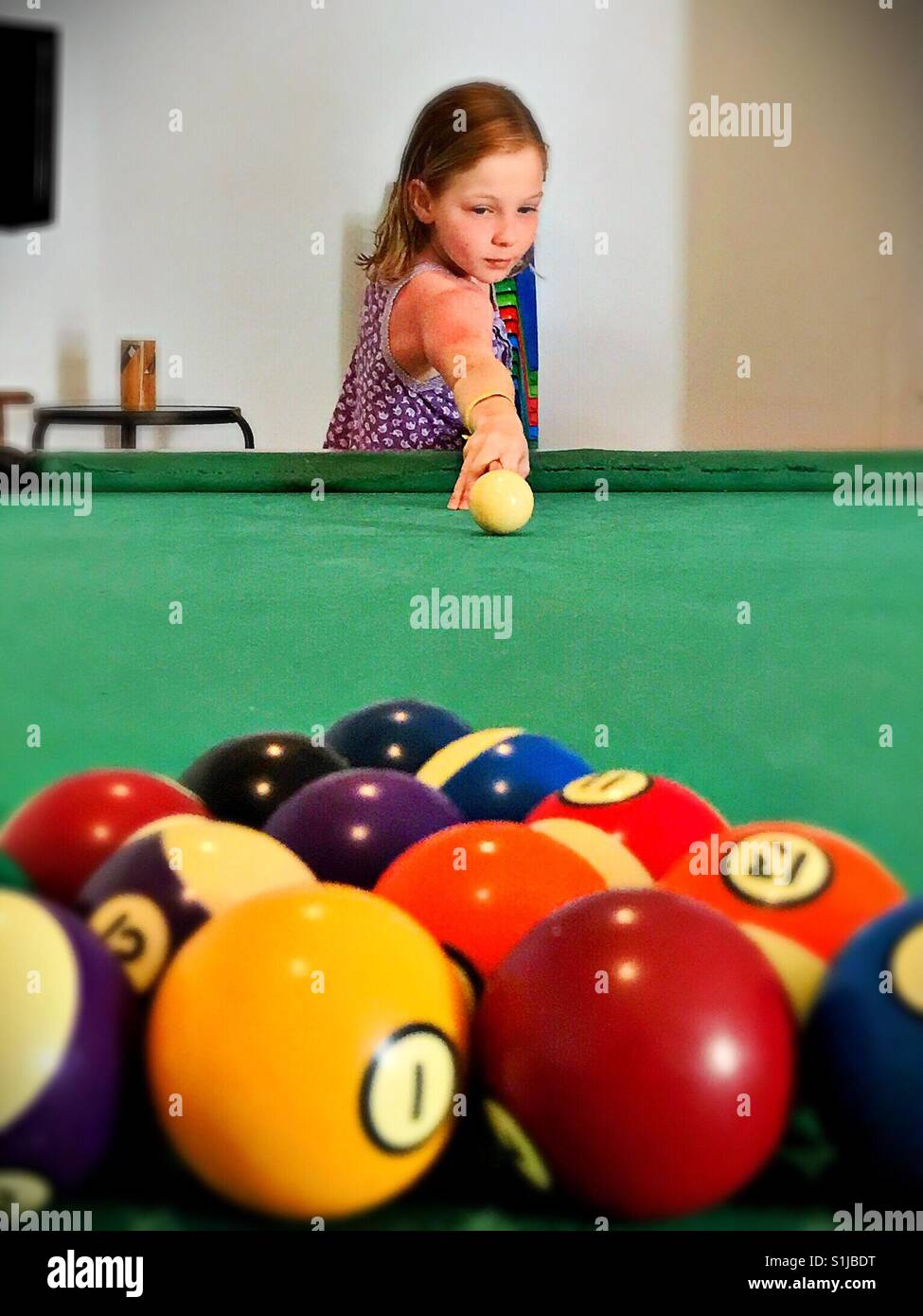 A young girl lines up a break shot Stock Photo - Alamy