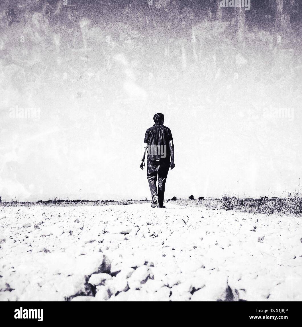 Man walking from behind in a deserted road Stock Photo - Alamy