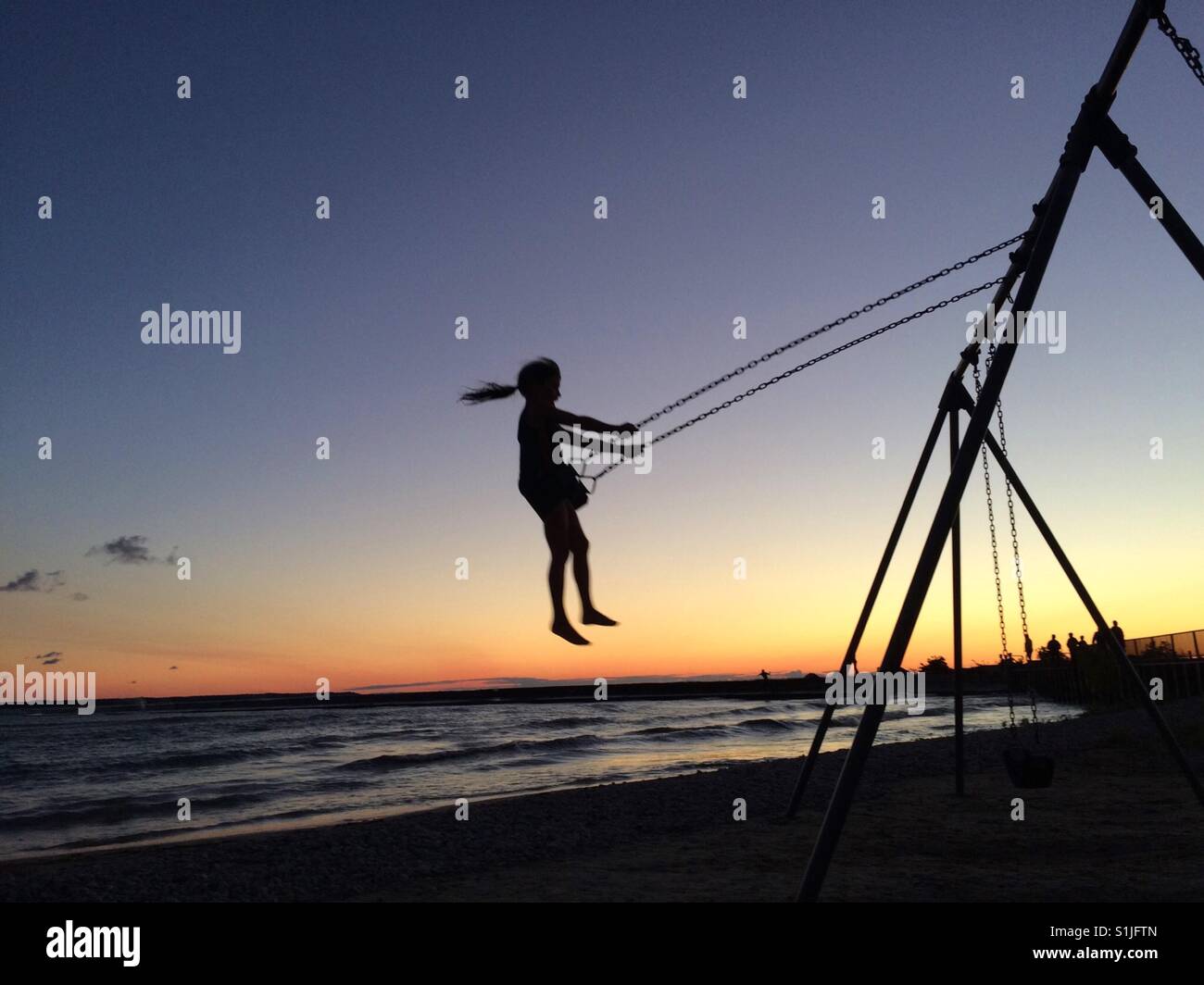 A sunset swing Stock Photo - Alamy