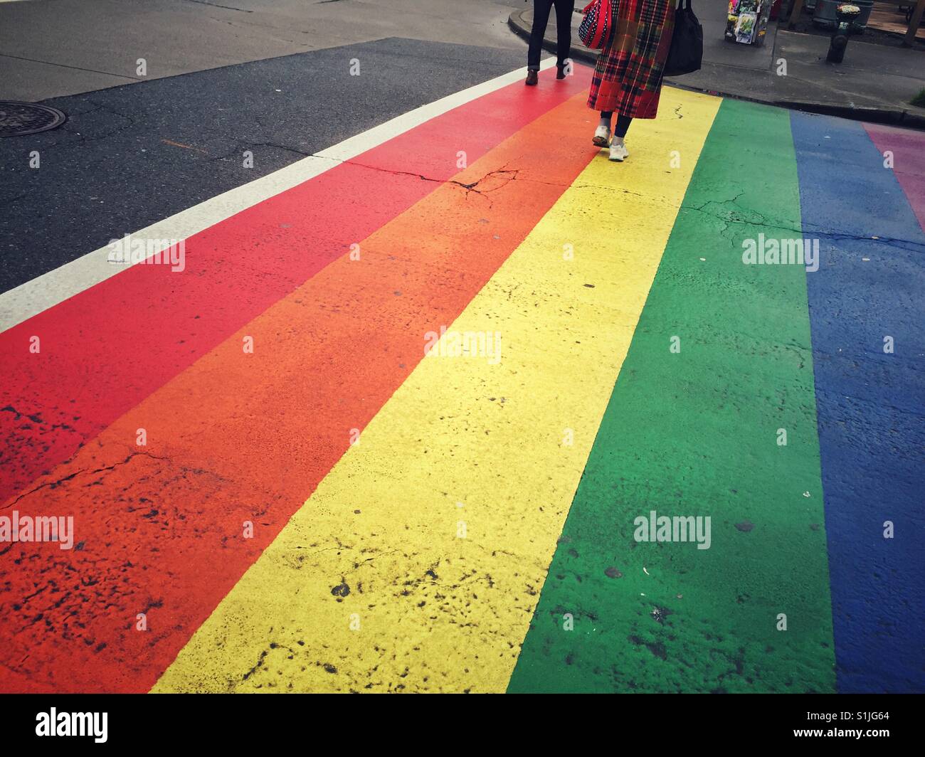 People walking on rainbow colored pedestrian crosswalk in Capitol Hill ...