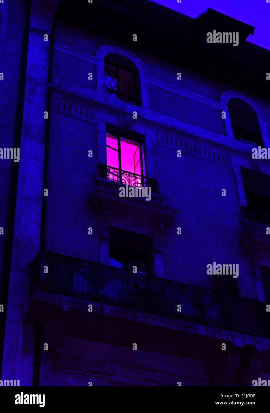 Purple light from a blue building Stock Photo - Alamy