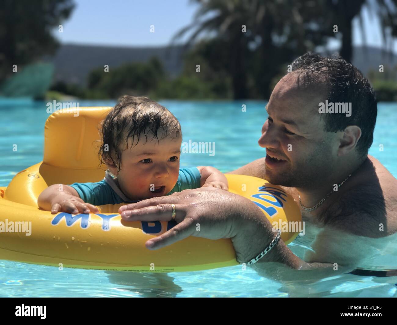 Father and baby son in swimming pool Stock Photo - Alamy