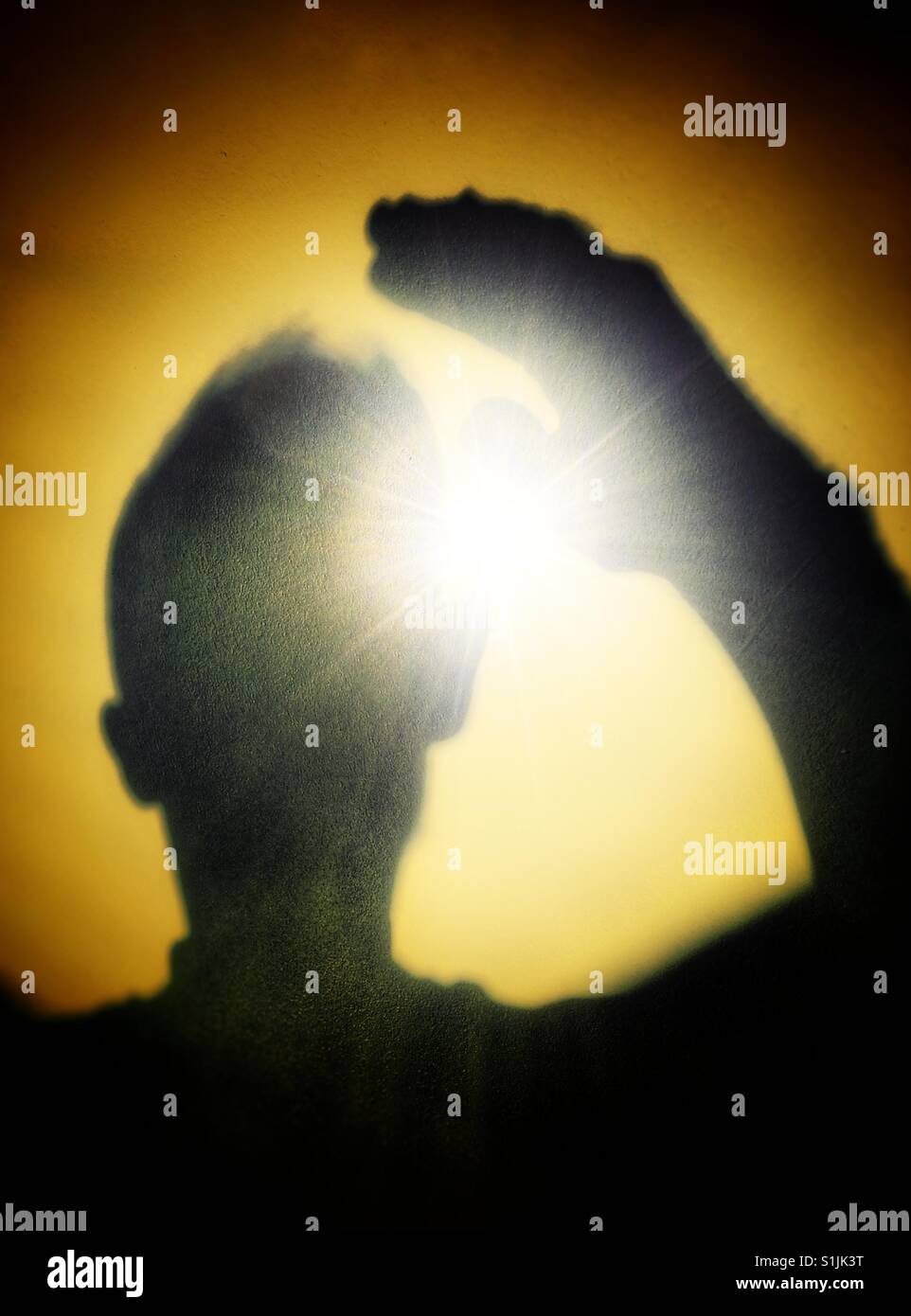 Man shading eyes an looking into the sun Stock Photo - Alamy