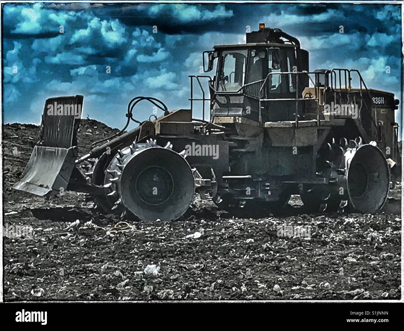 Tractor plowing at the garbage dump Stock Photo - Alamy