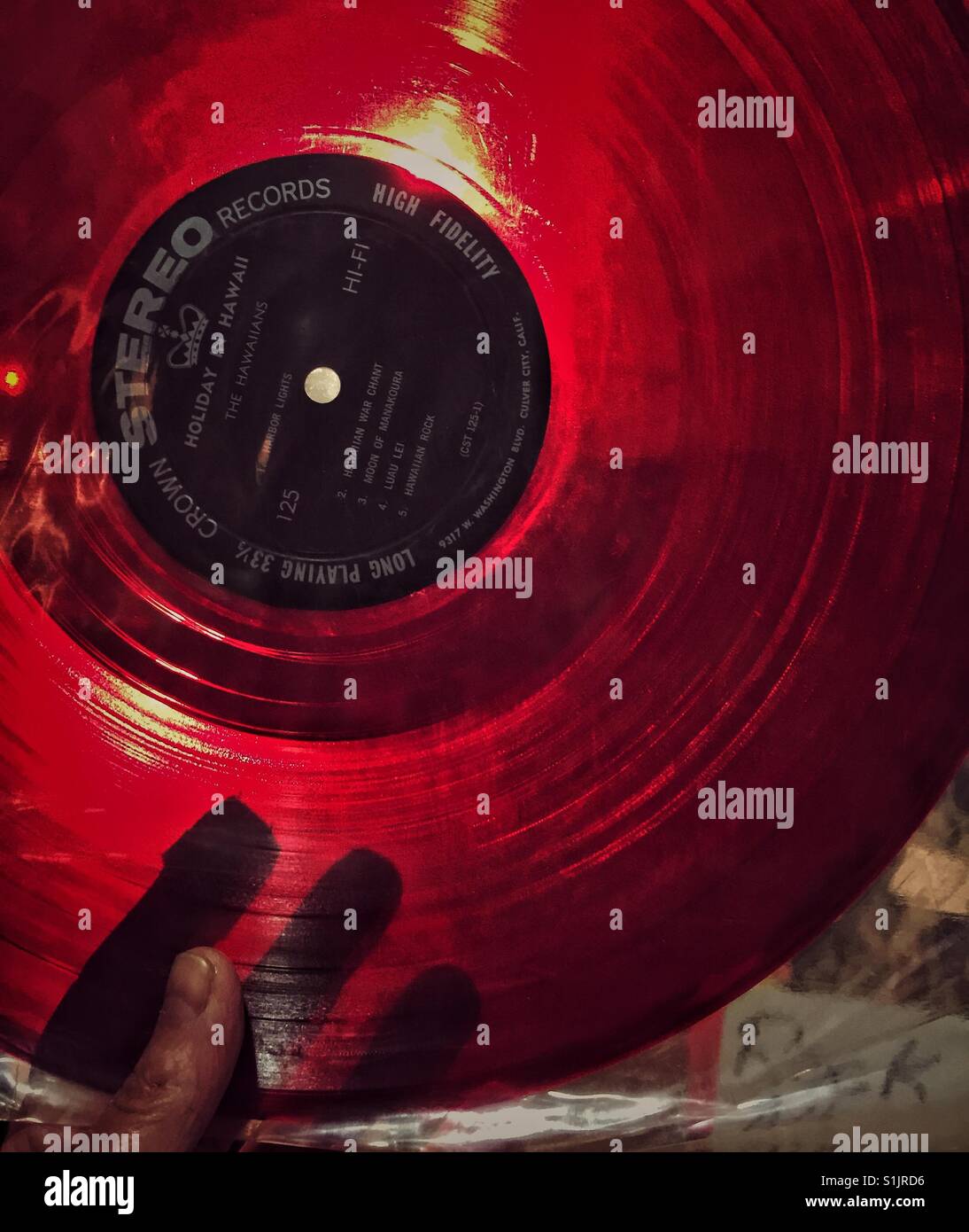 Hand holding Red vinyl record Stock Photo - Alamy