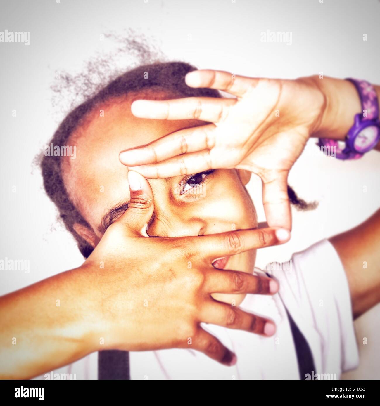 A young girl using her hands as a frame Stock Photo - Alamy