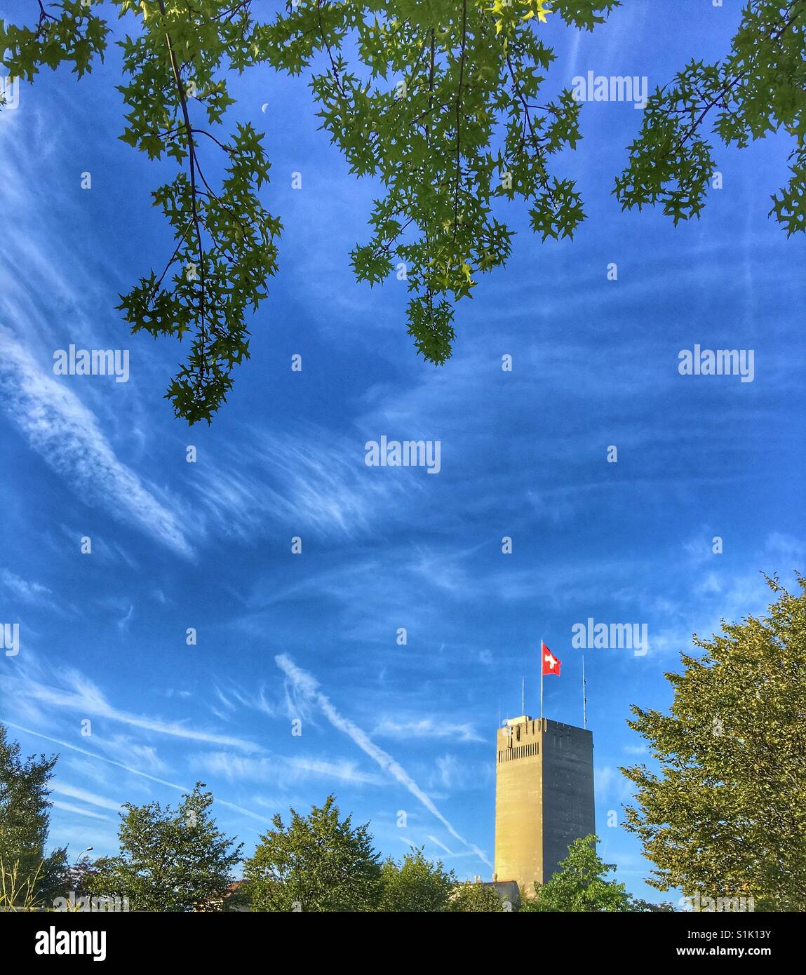 View over a tall building with a Swiss flag on top Stock Photo - Alamy