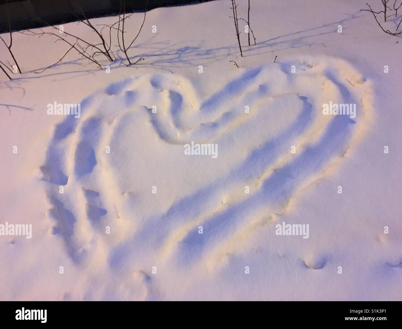 Heart in snow Stock Photo - Alamy