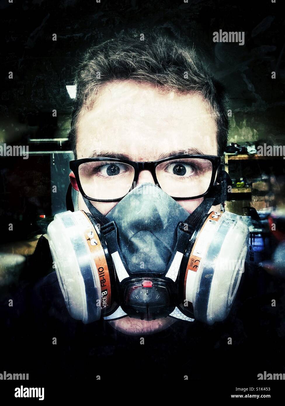 A young man wearing a breathing mask or respirator or gas mask Stock ...
