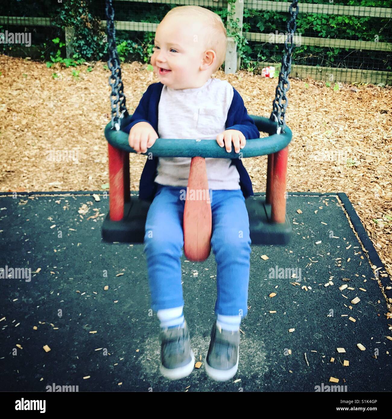 Baby boy in baby swing hi-res stock photography and images - Alamy