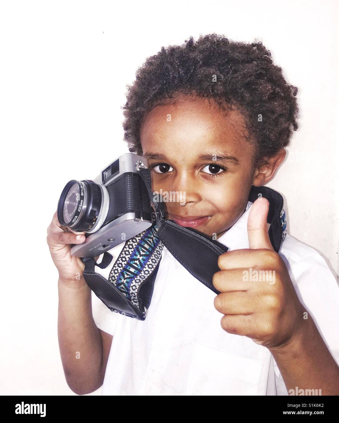 Boy with a camera making a thumbs up sign Stock Photo - Alamy