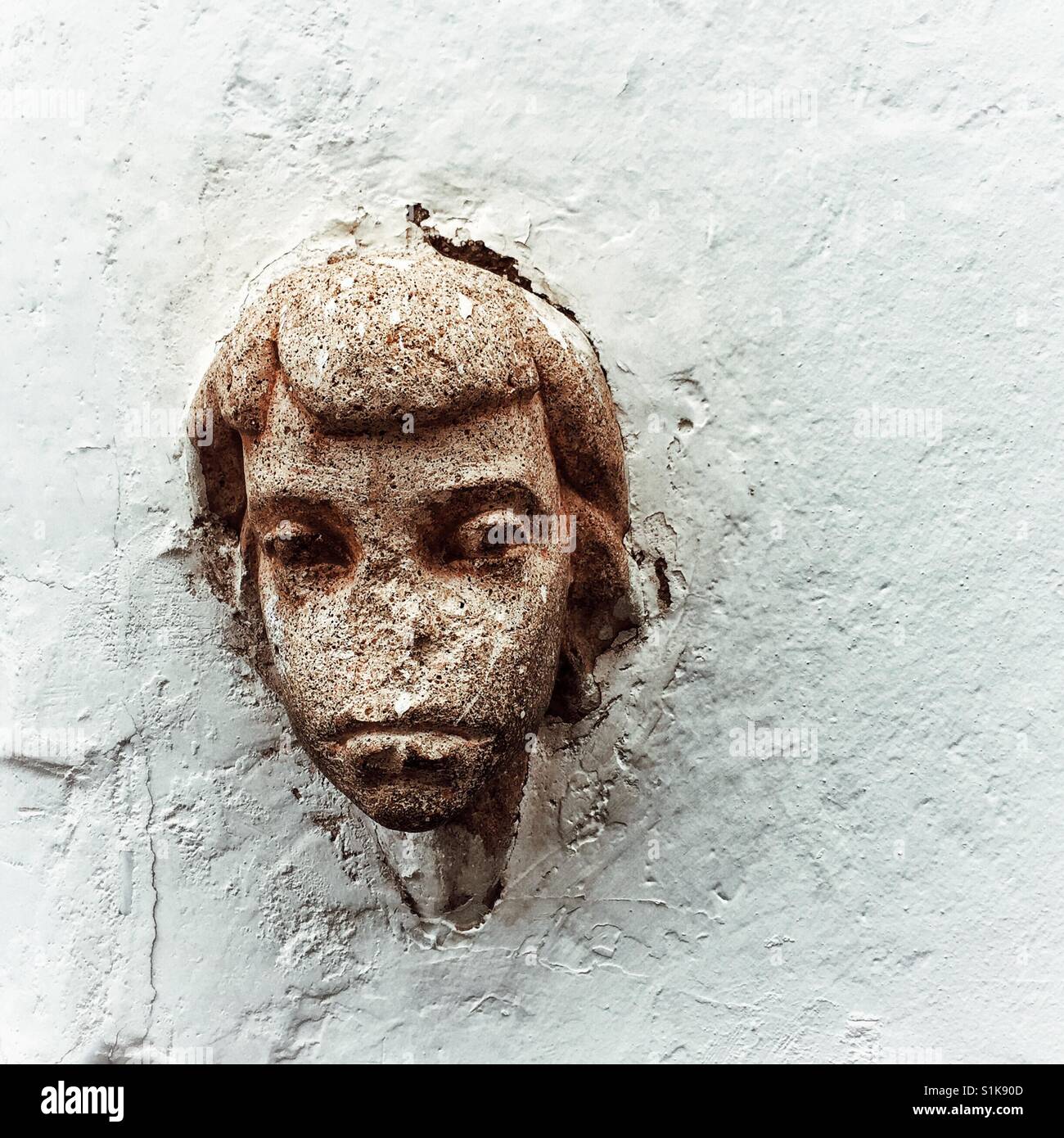 Noseless bust decorating wall of a house in Cusco, Peru Stock Photo - Alamy