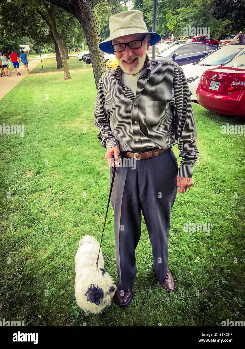 Old man with a dog smartphone stock photos and images - Alamy