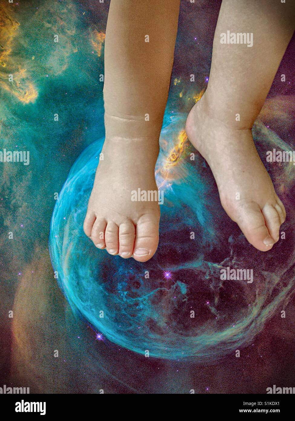 Little feet standing on world Stock Photo - Alamy