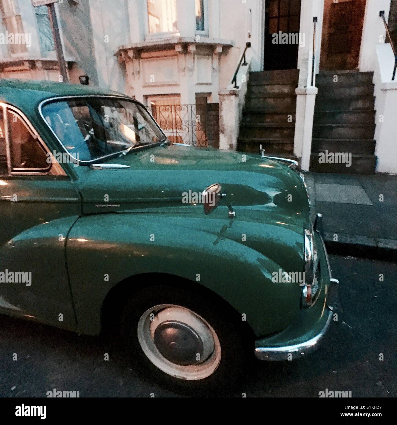 Dark Green classic Morris Minor car outside London terrace house Stock ...
