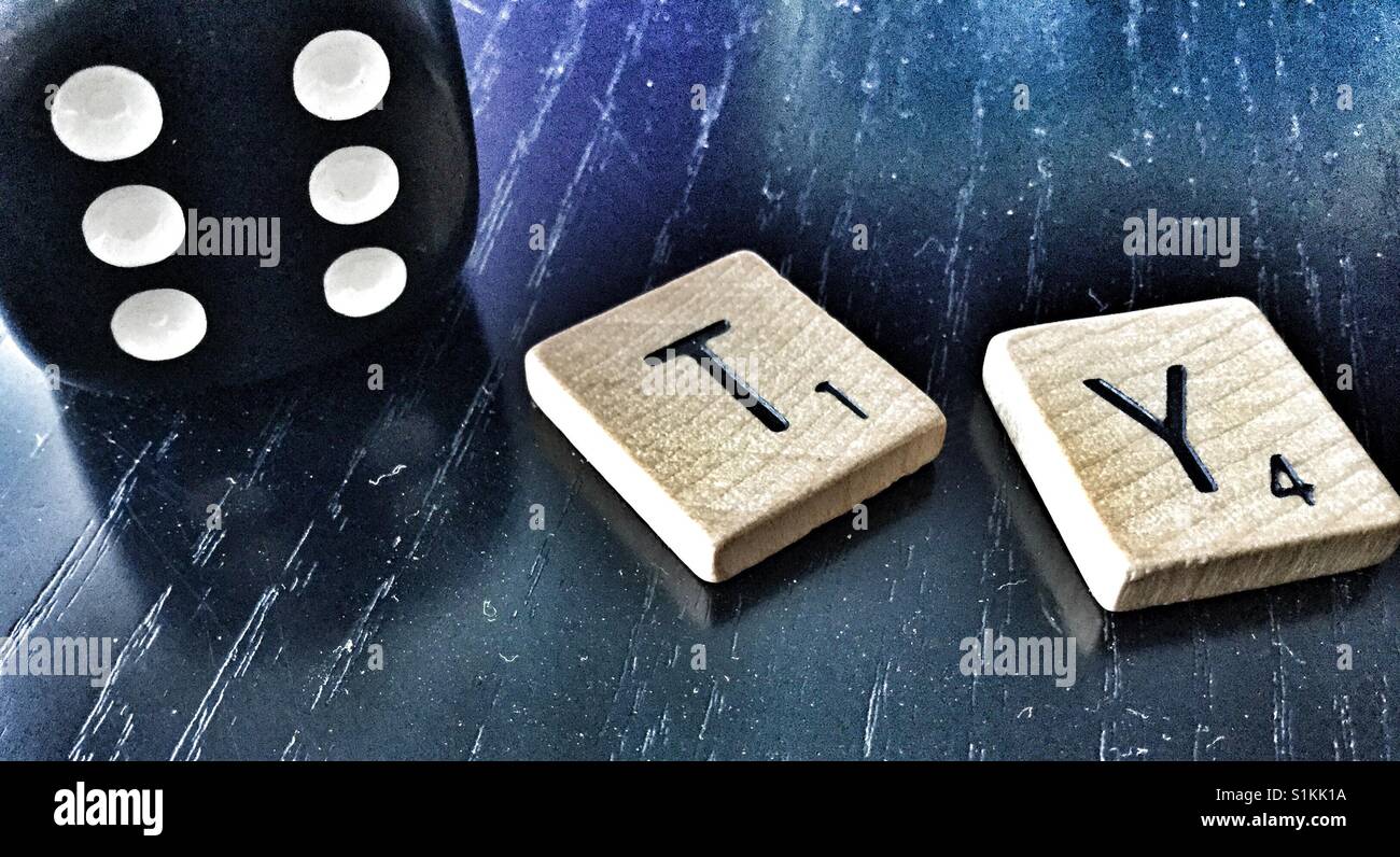 Black dice and scrabble letters Stock Photo - Alamy