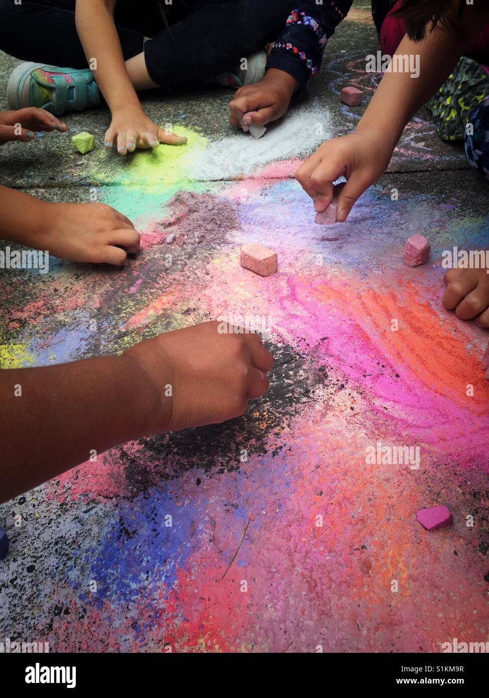 Children coloring pavement with chalk Stock Photo - Alamy