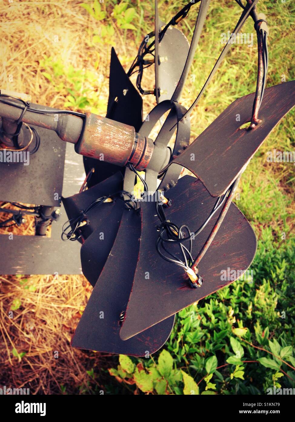 Backside of wind plates on yard decor windmill Stock Photo - Alamy