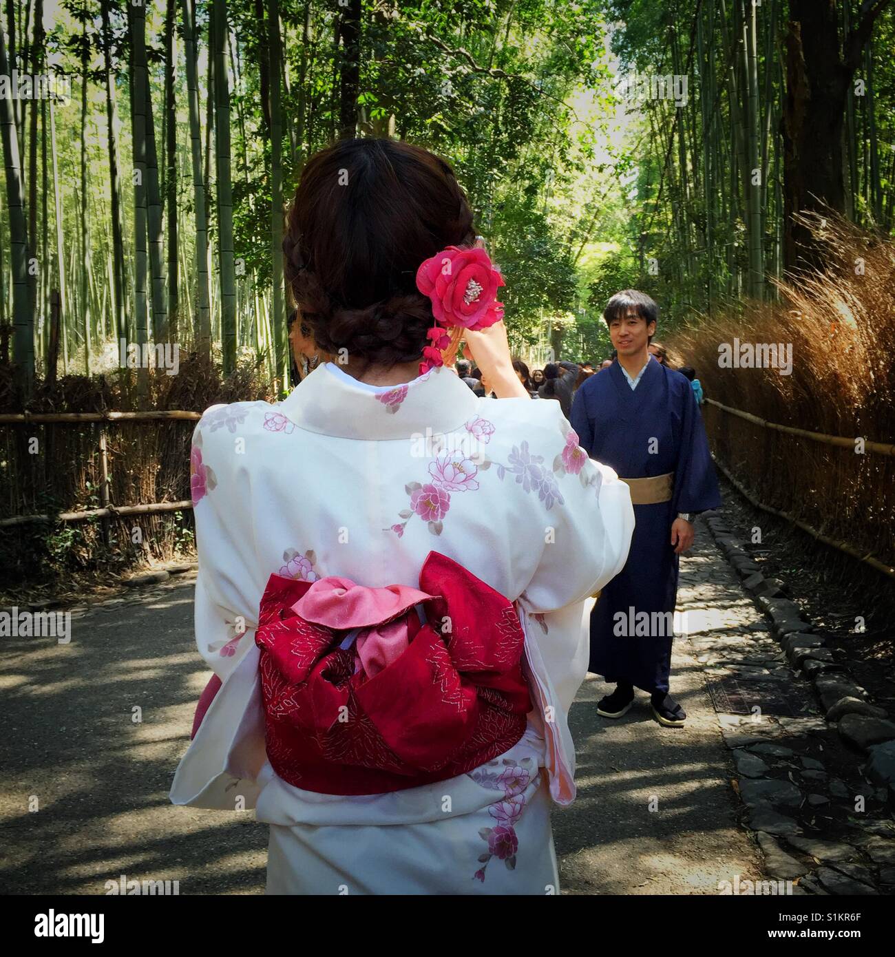 Clad in traditional kimono young Japanese woman taking picture of her ...
