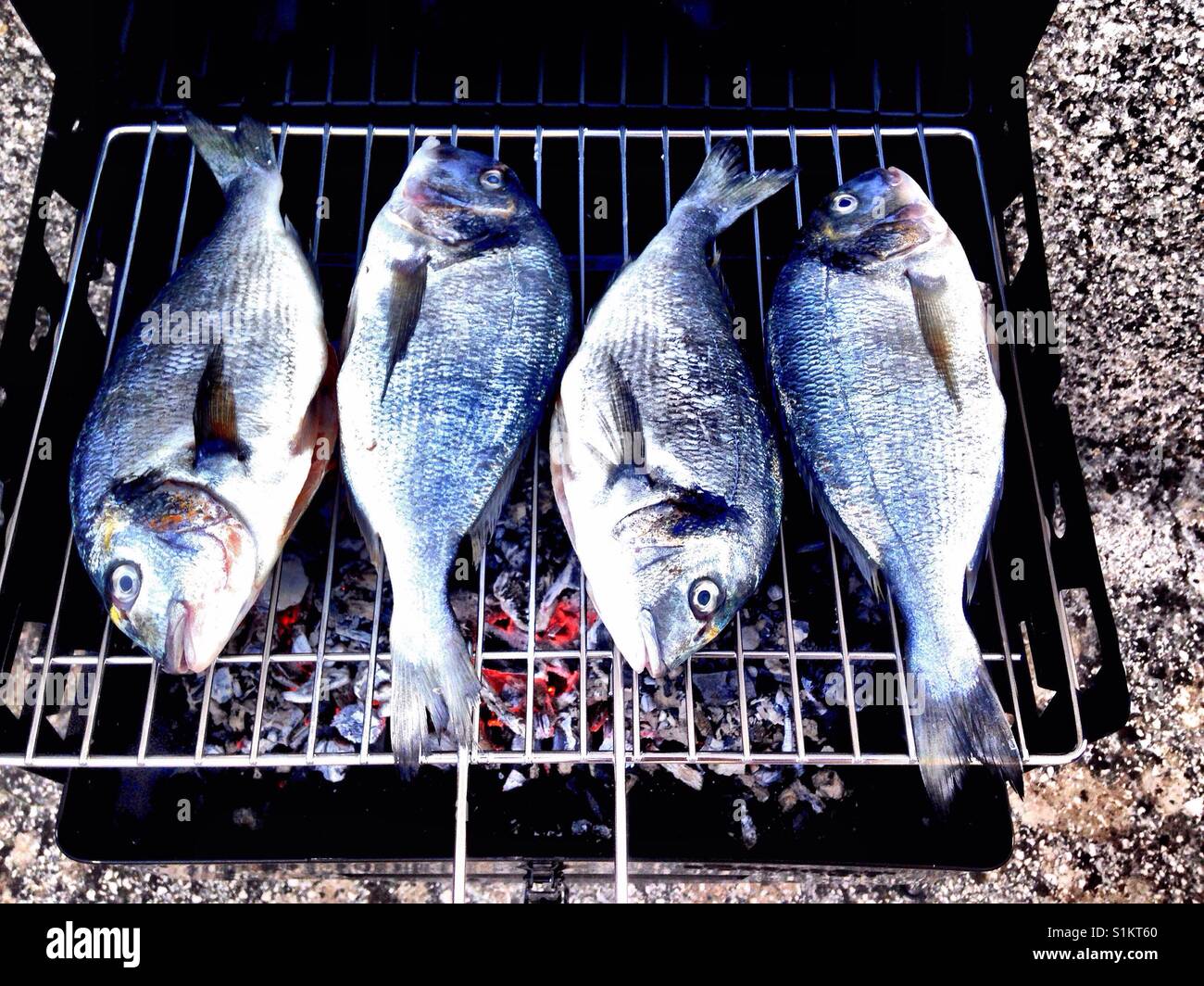 Fish on grill Stock Photo - Alamy