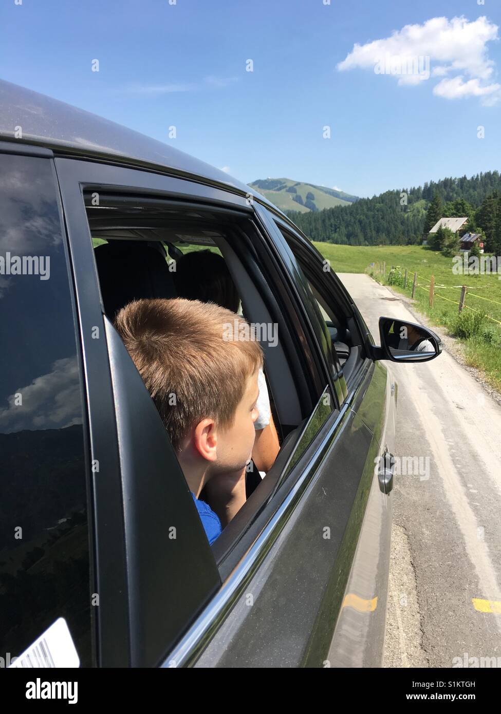 Boy gazing out of window hi-res stock photography and images - Alamy