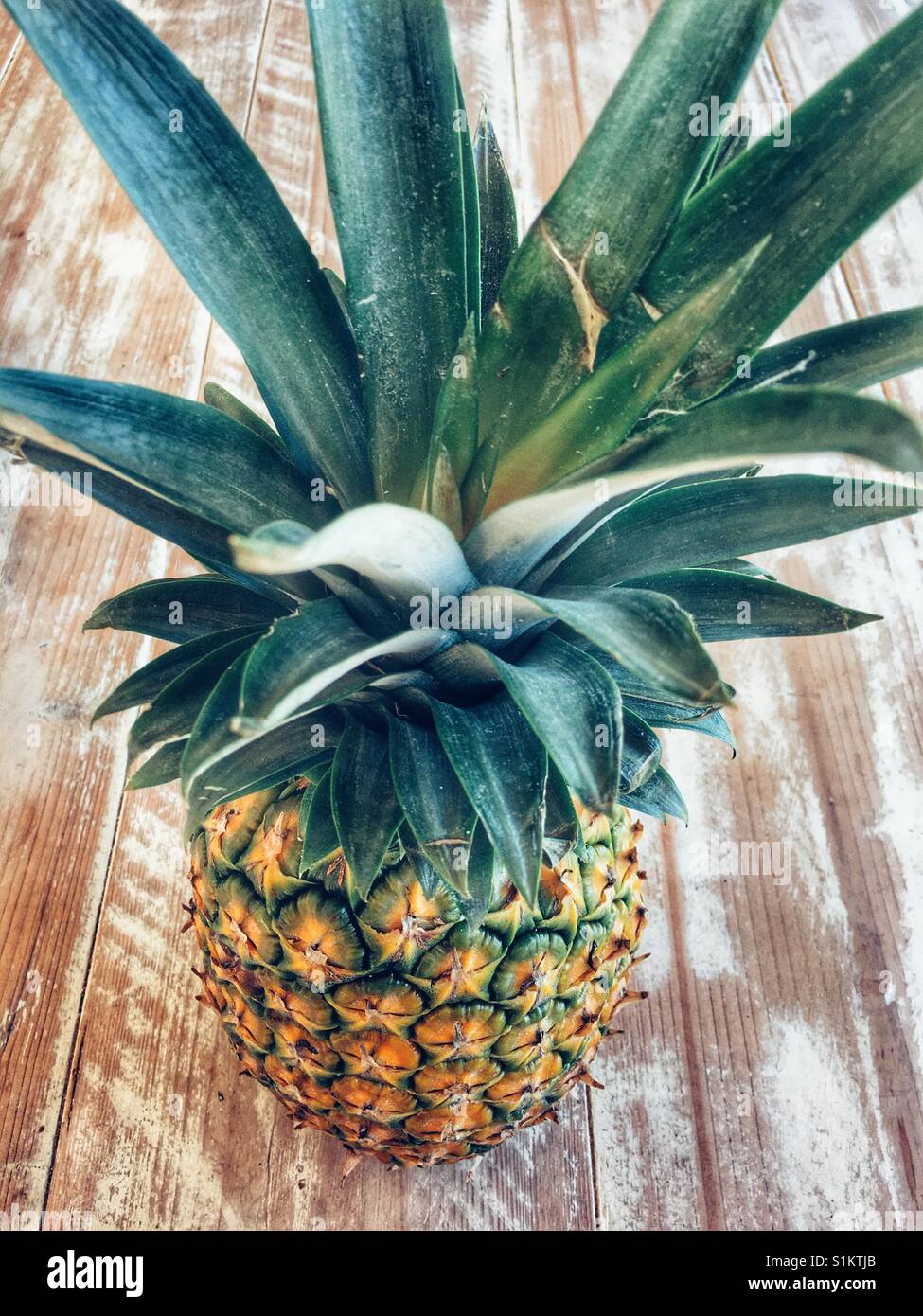 Pineapple on a table top Stock Photo - Alamy