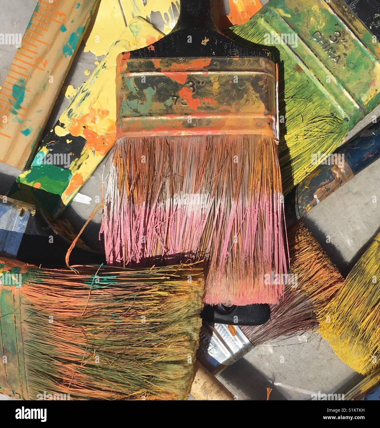 Wet paintbrushes from a mural project on a wall in Detroit, Michigan ...