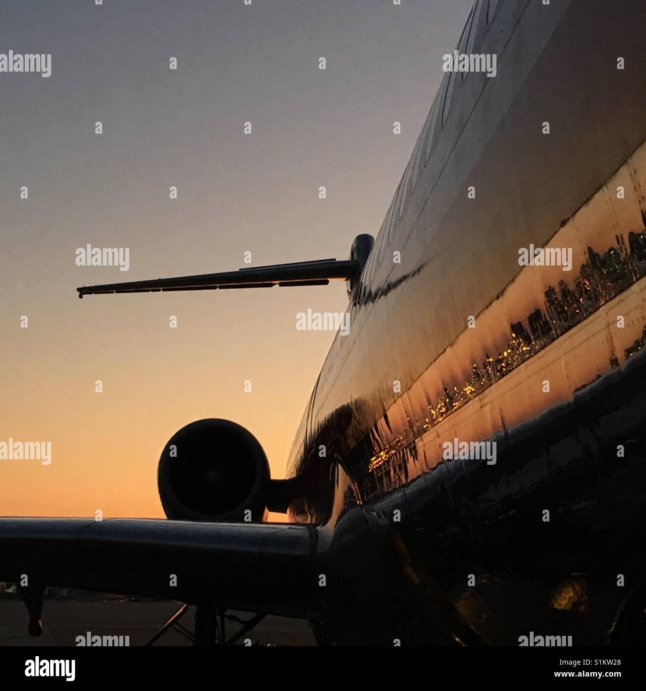 Morning sunrise reflecting side of airliner Stock Photo - Alamy
