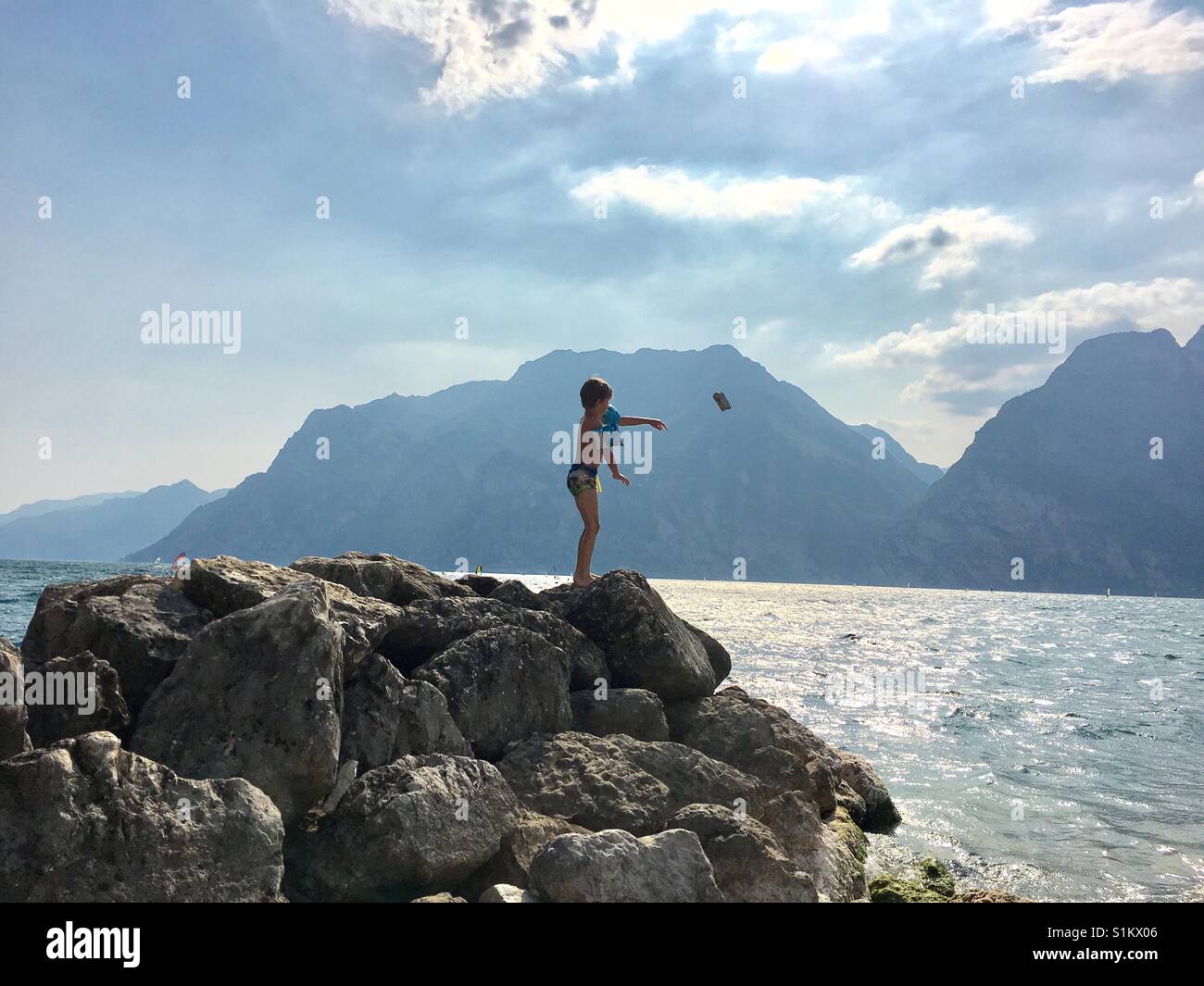 Boy throwing rock Stock Photo - Alamy