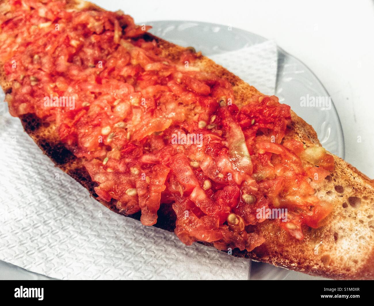 Tomatoes on toast, typical breakfast in a Spanish cafe Stock Photo - Alamy
