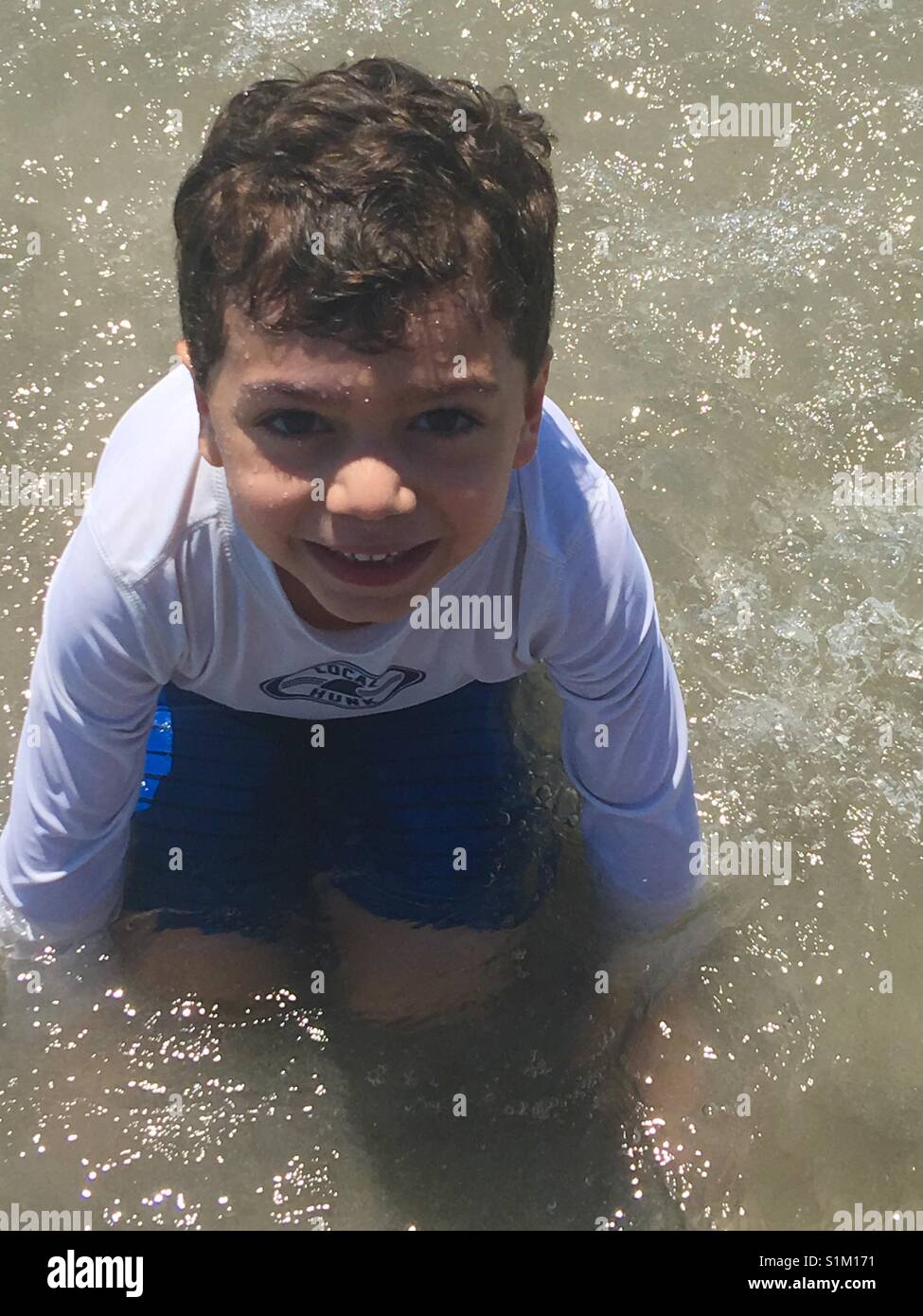 Boy in water Stock Photo - Alamy