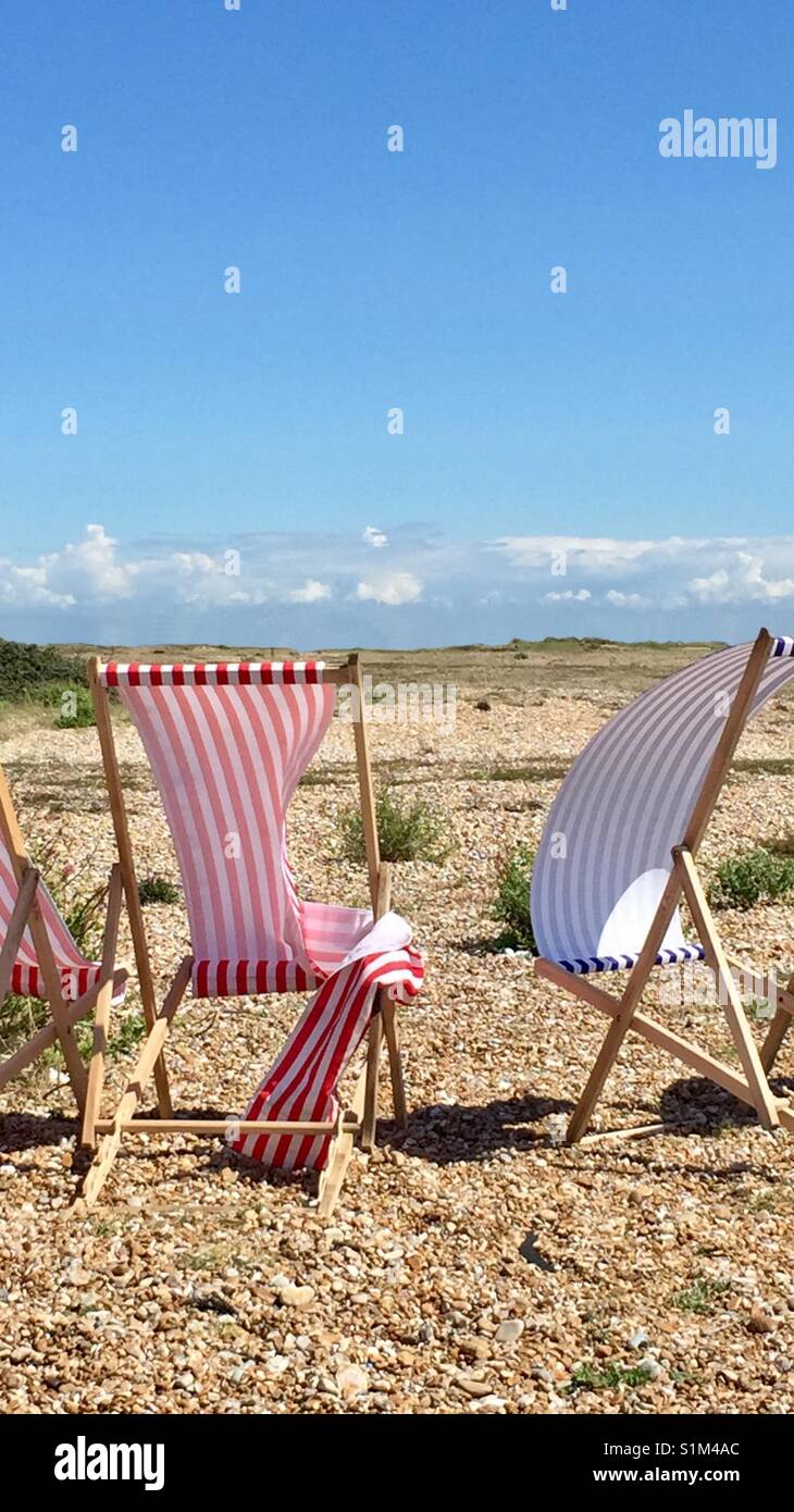 Tattered Deck chairs on the beach at Dungeness Stock Photo - Alamy