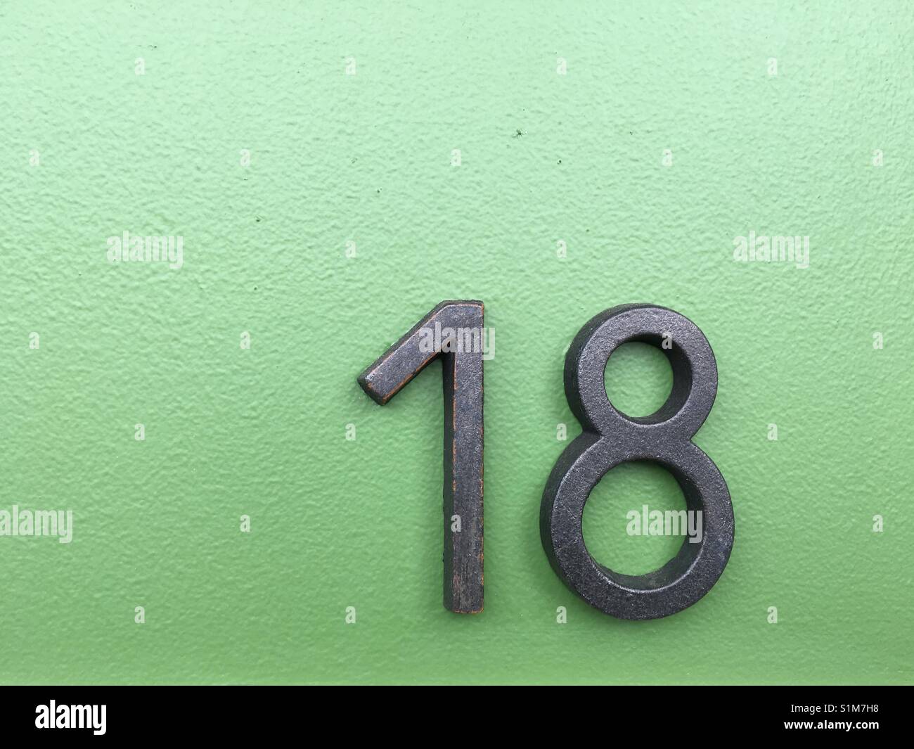 Number 18 against green background Stock Photo - Alamy
