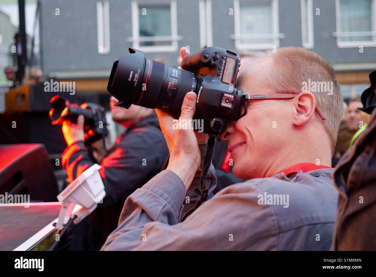 Photographer aiming Camera at stage of Air Guitar World Championships ...