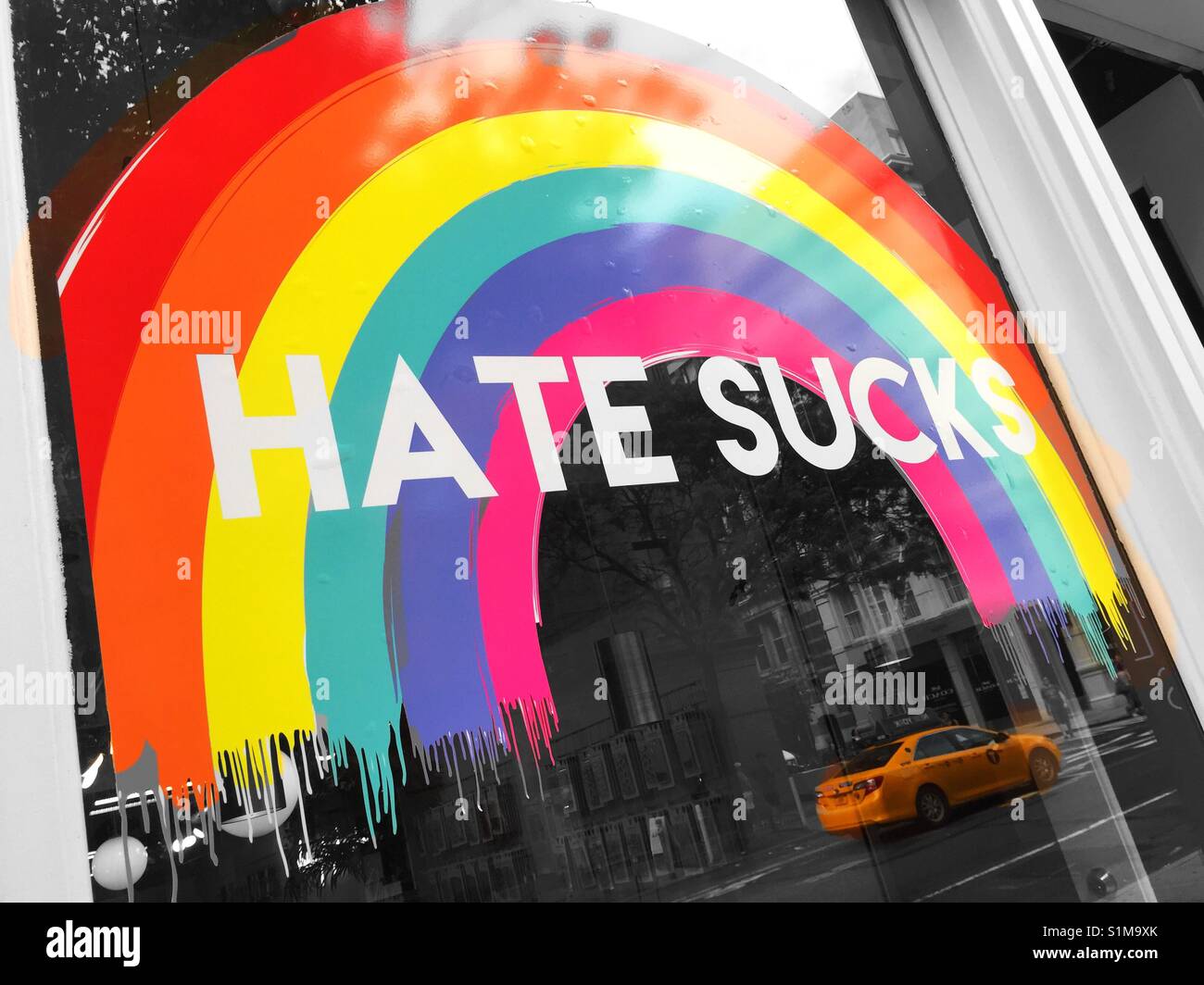 Hate sucks and rainbow painted on store window, NYC, USA Stock Photo ...