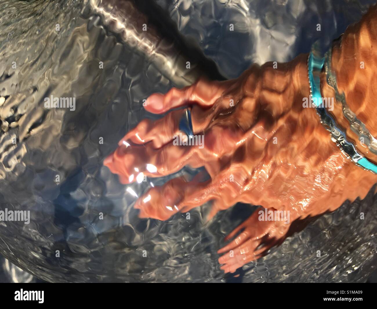 Hand through water fountain Stock Photo - Alamy