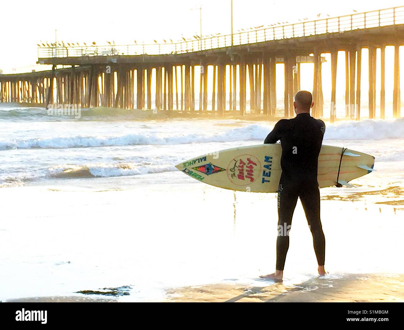 Surfer On Beach Looking At Waves High Resolution Stock Photography and ...