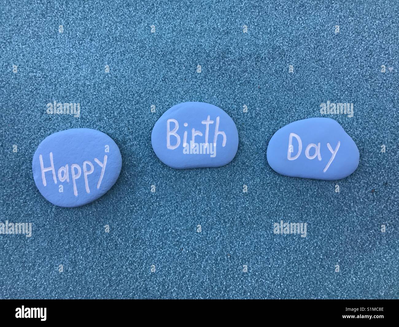 Happy Birthday carved on three stones Stock Photo - Alamy