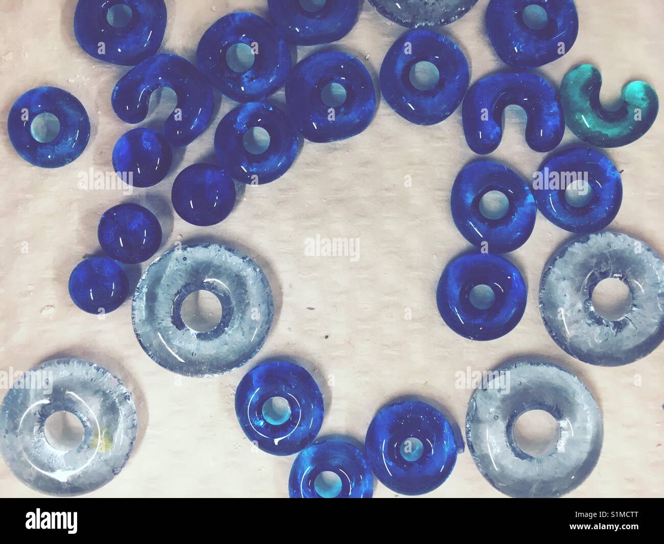 Handmade transparent blue glass circles Stock Photo - Alamy