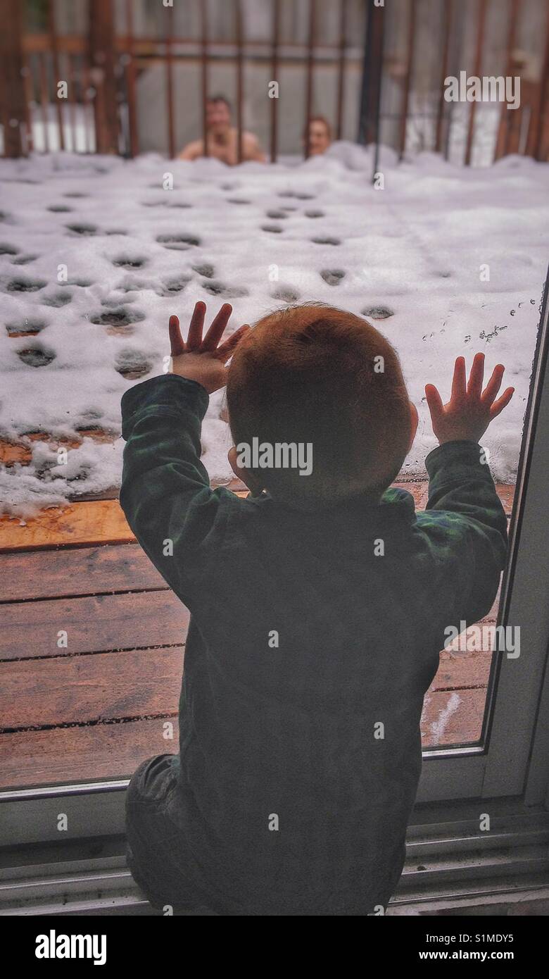 Baby looking out the window Stock Photo - Alamy