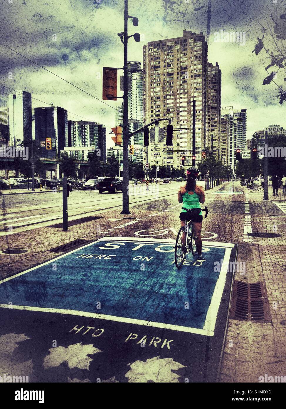 Female cyclist stopped at a red light Stock Photo - Alamy