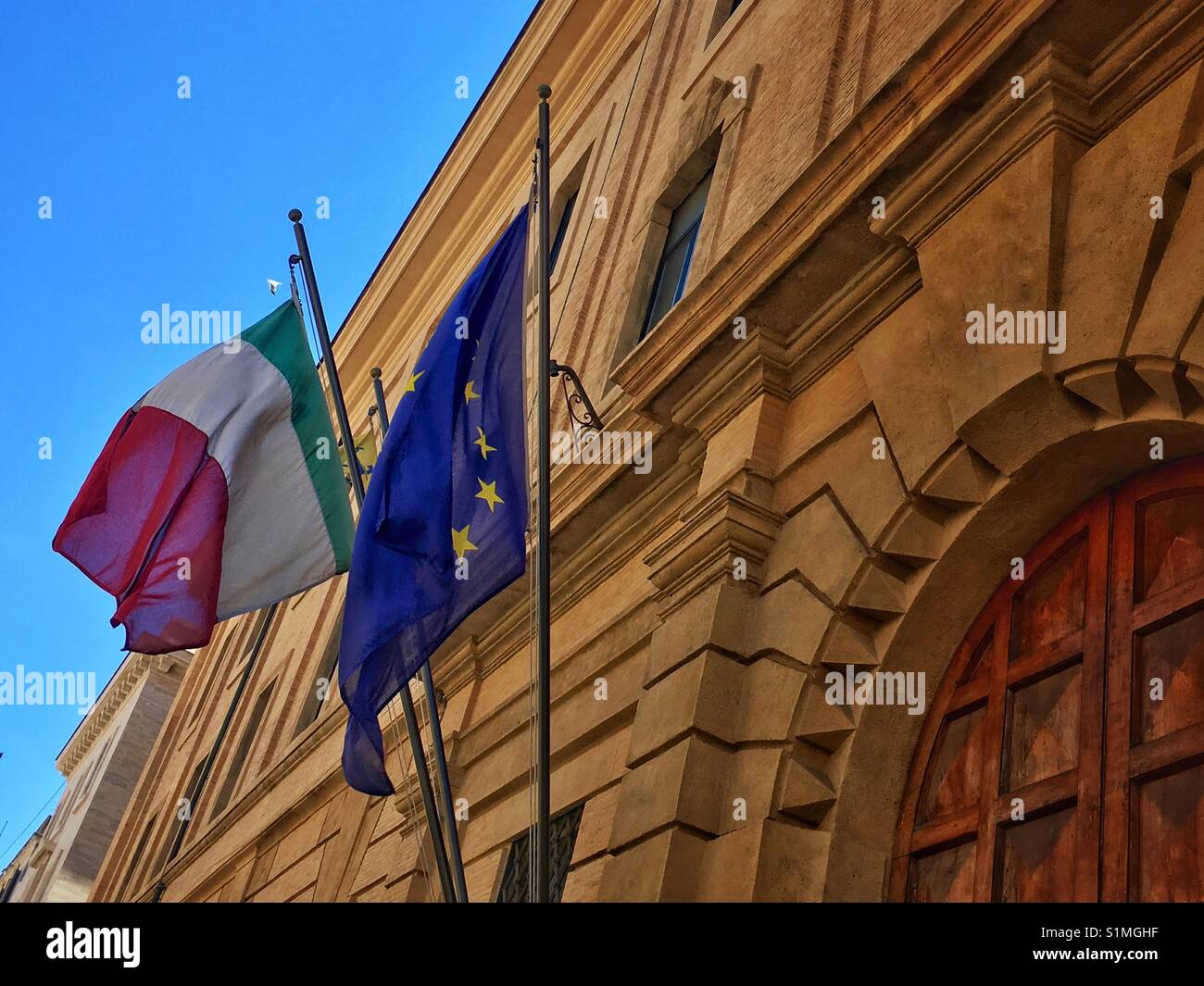 The European Union and Italian National flag hang from a building in ...