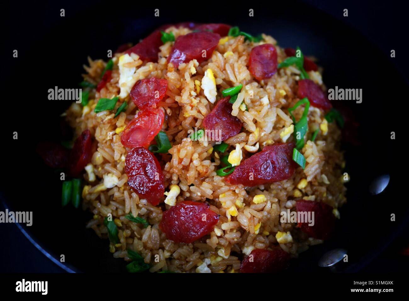 Homemade fried rice with Chinese sausage, eggs, and green onions Stock ...