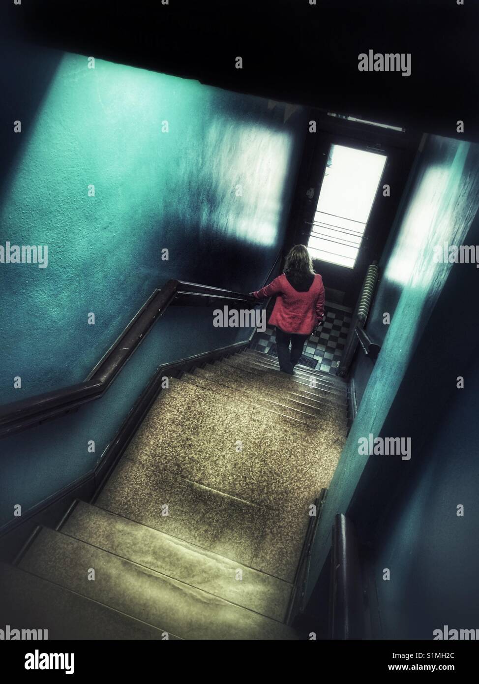 Woman descending staircase in old office building Stock Photo - Alamy