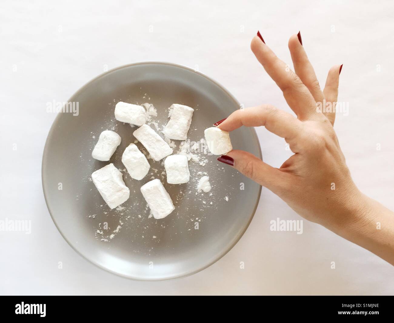 Hand holding sweets hi-res stock photography and images - Alamy