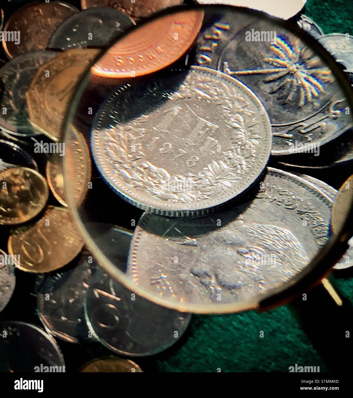 Magnifying glass money coins hi-res stock photography and images - Alamy