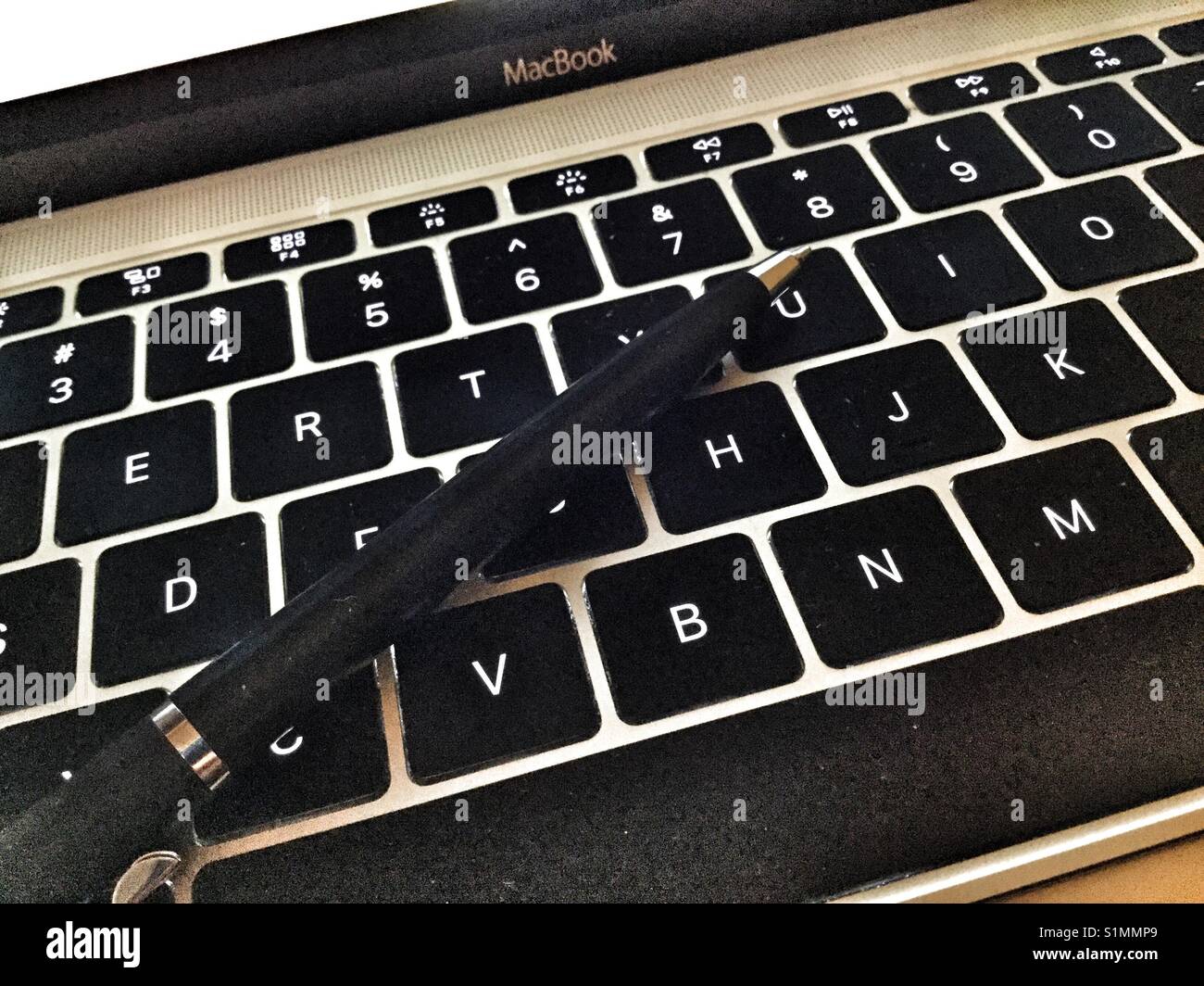 Black pen and keyboard Stock Photo - Alamy